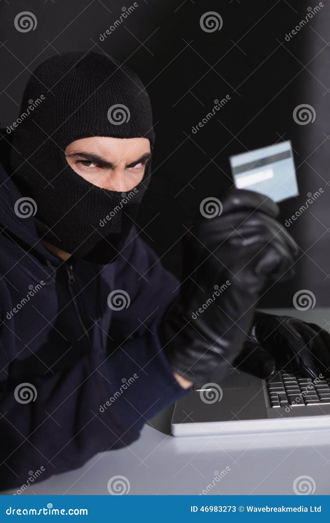 An Angry Hacker In A Mask With A Hood Infiltrates Data Servers And ...