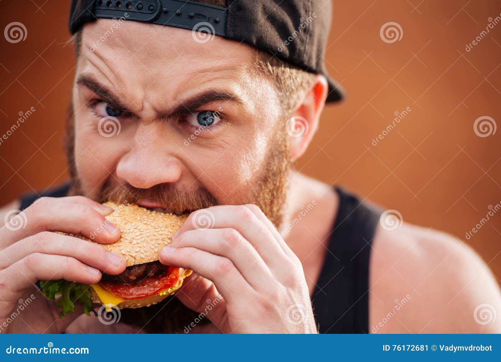 Angry Irritated Young Man Eating Hamburger Outdoors Stock Image - Image ...