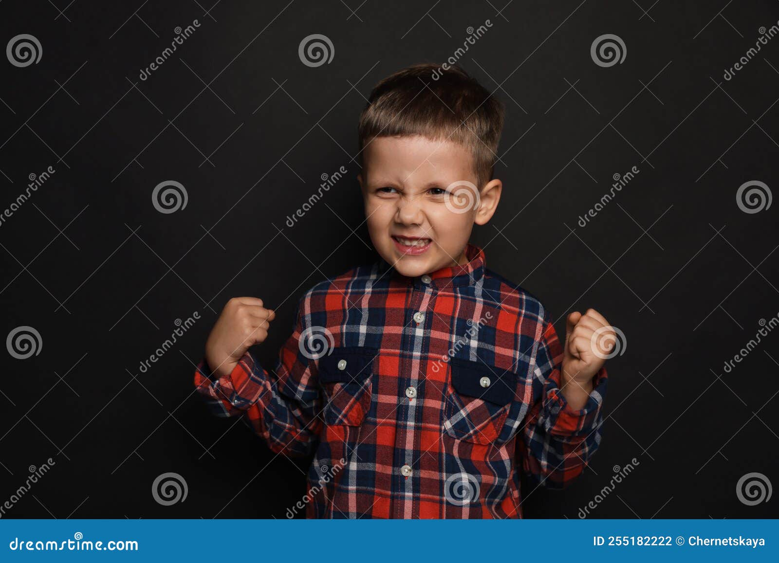 Angry Little Boy on Black Background. Aggressive Behavior Stock Photo ...