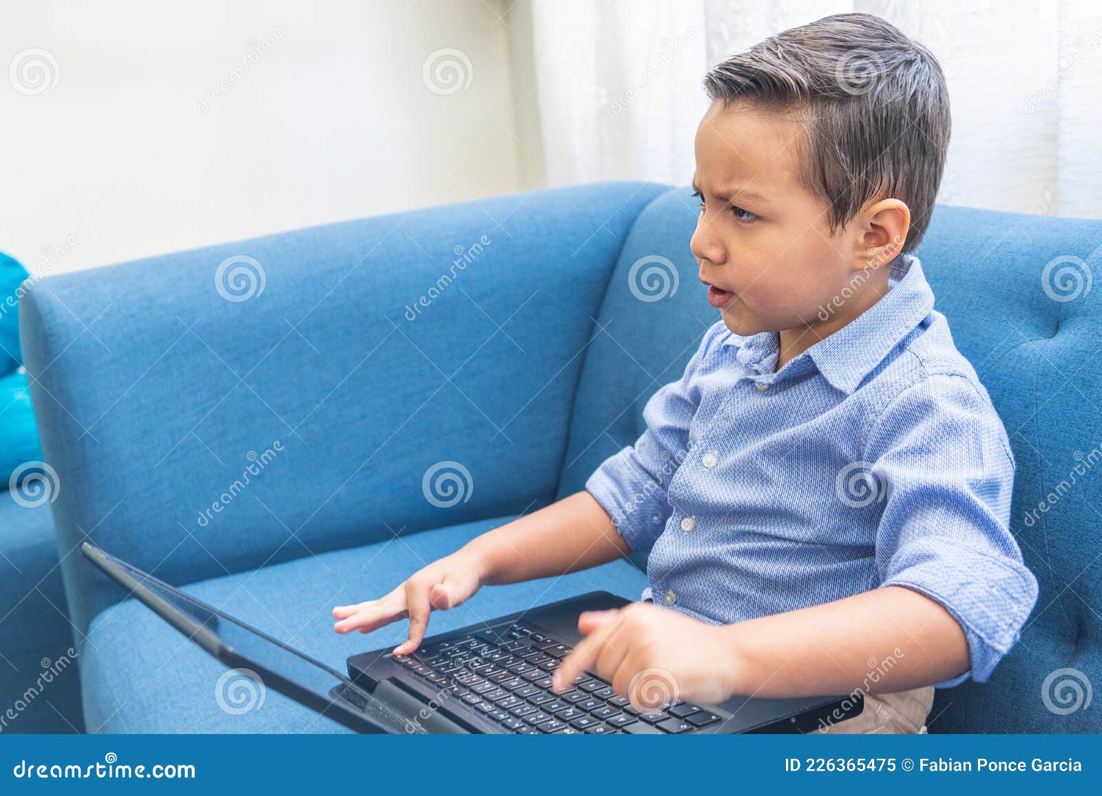 Angry Little Latin Boy Using a Laptop Stock Image - Image of connection ...