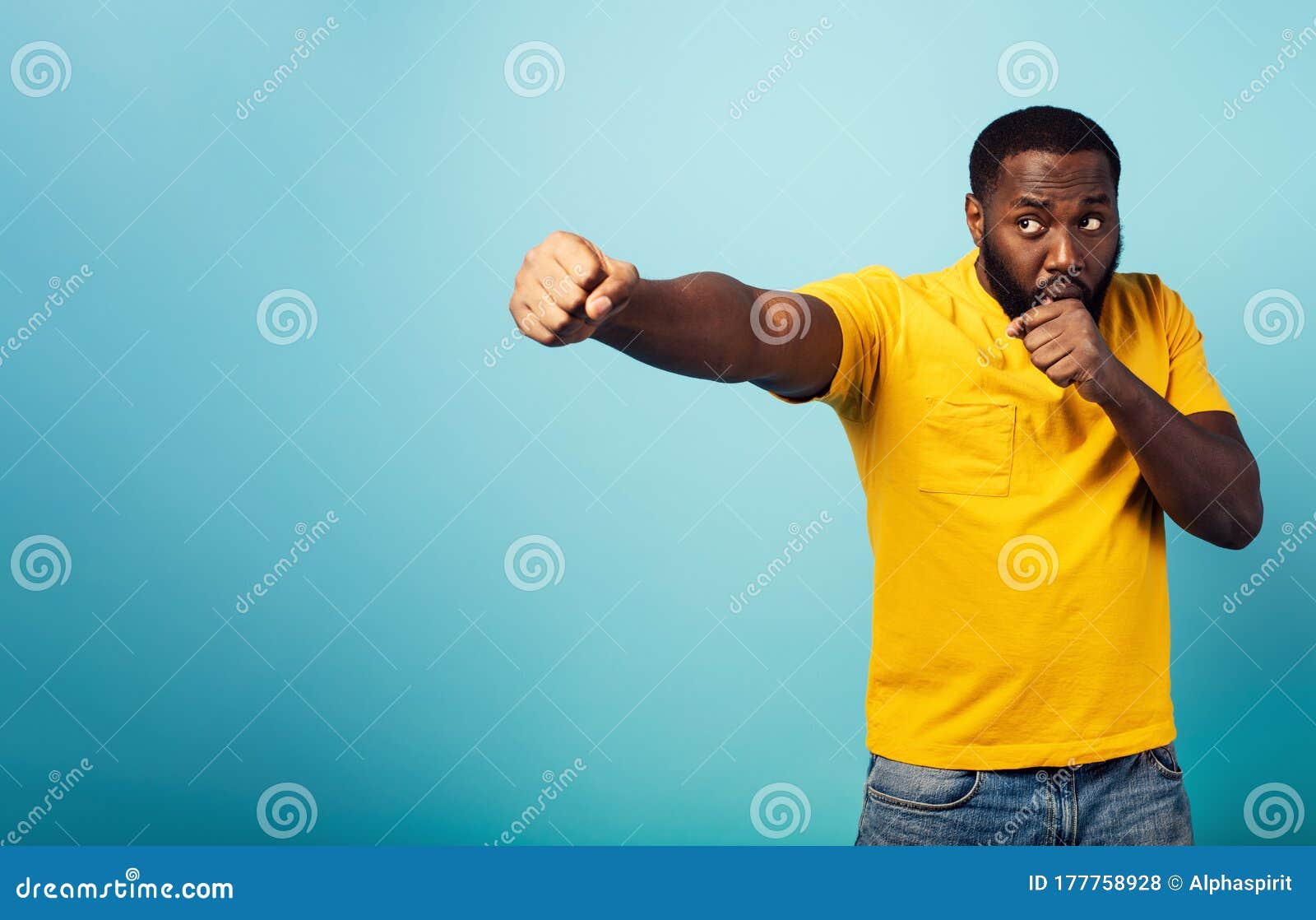 Angry Man Attacks with a Punch Something. Blue Background Stock Photo ...