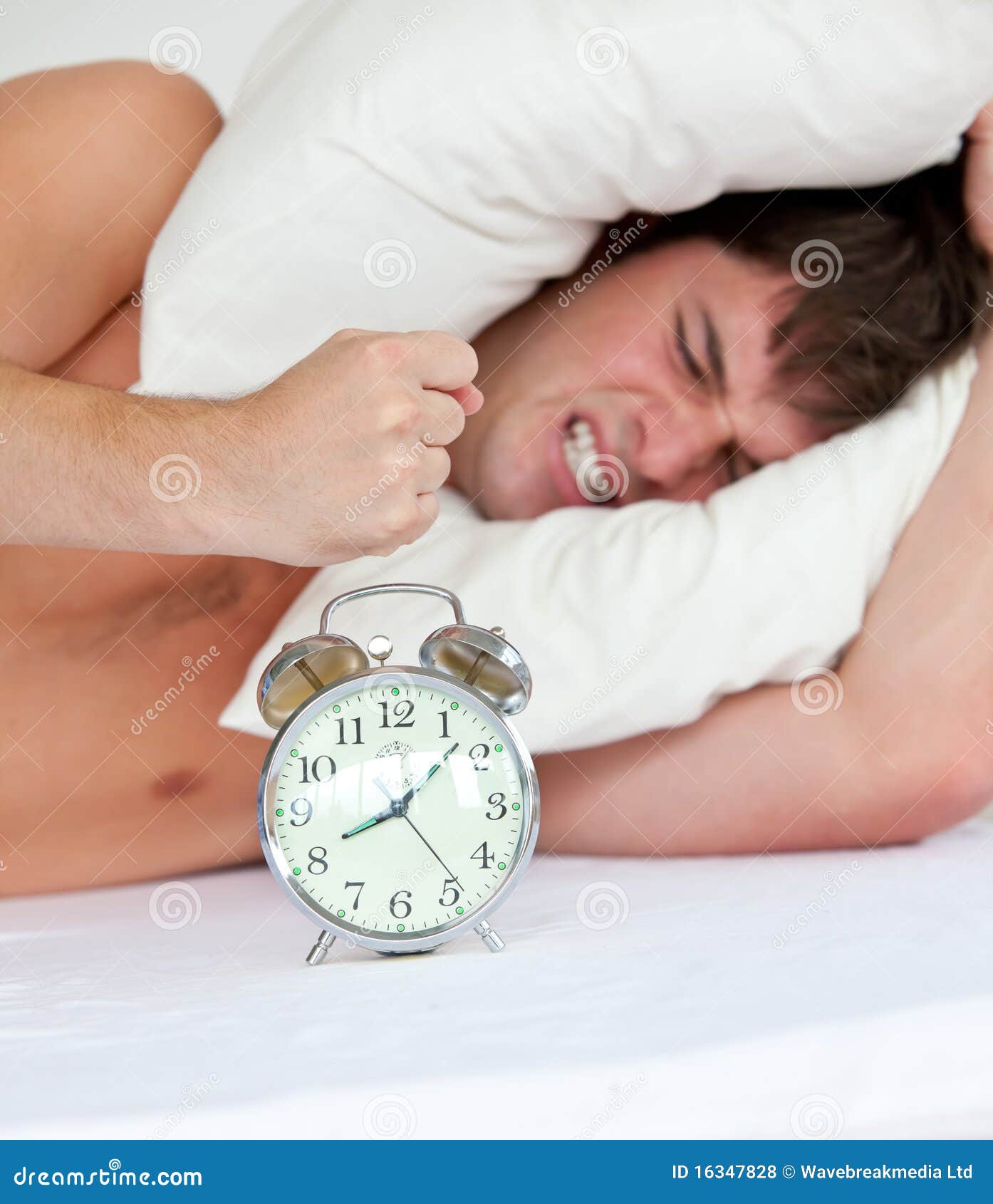 Angry Man on Bed Stressed by His Alarm Clock Stock Photo - Image of ...