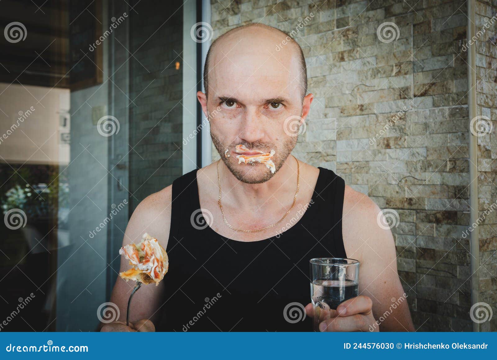 Angry Man Eating at the Table in a T-shirt Stock Photo - Image of ...