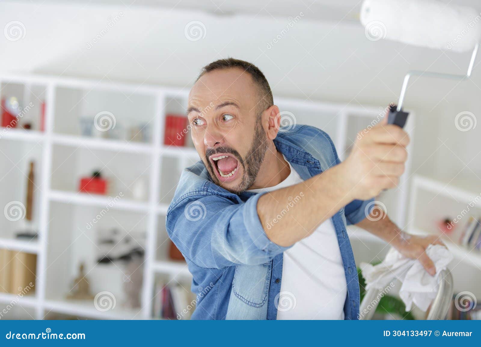 Angry man while painting stock image. Image of occupation - 304133497
