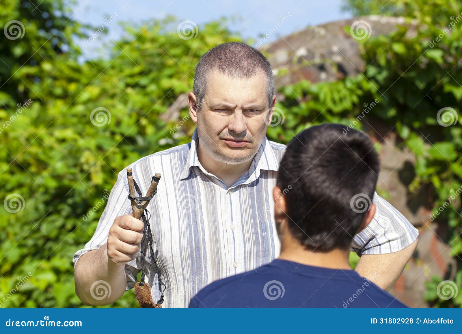 Angry man with slingshot stock photo. Image of public - 31802928