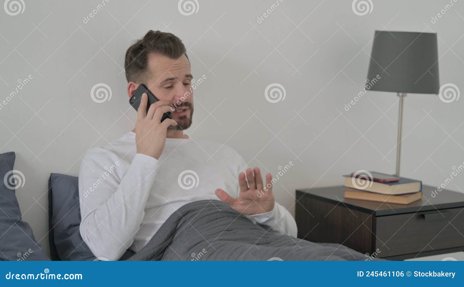 Angry Man Talking on Phone in Bed Stock Photo - Image of anger, talking ...