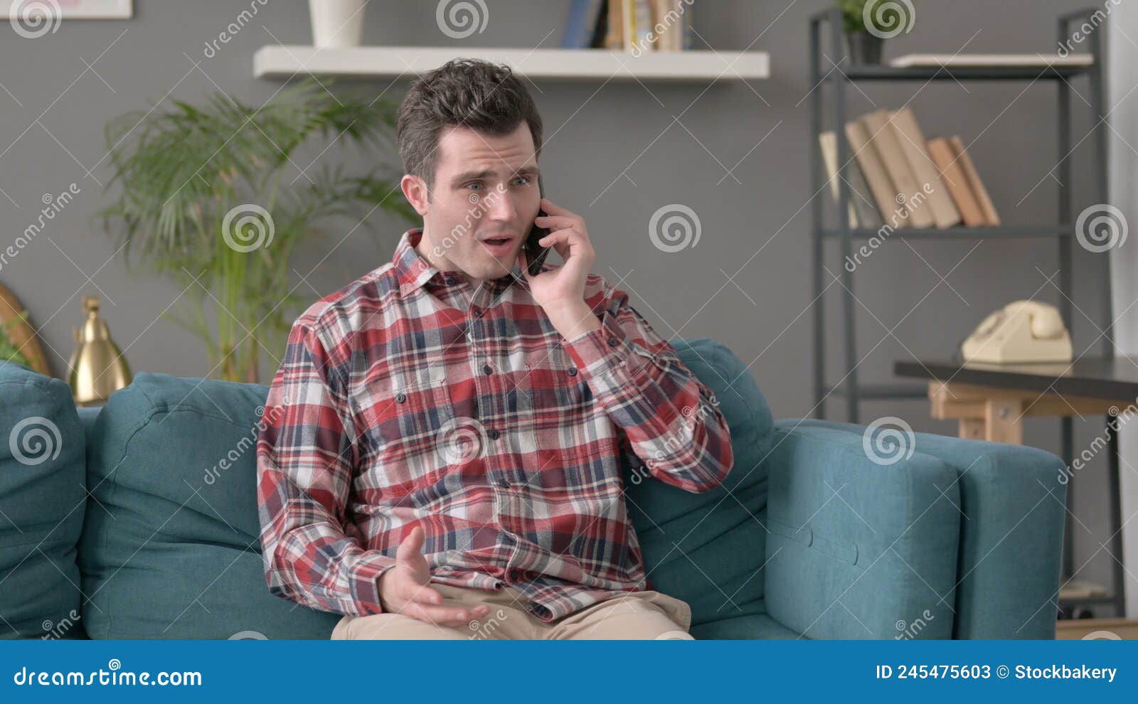 Angry Man Talking on Phone on Sofa Stock Image - Image of fighting ...