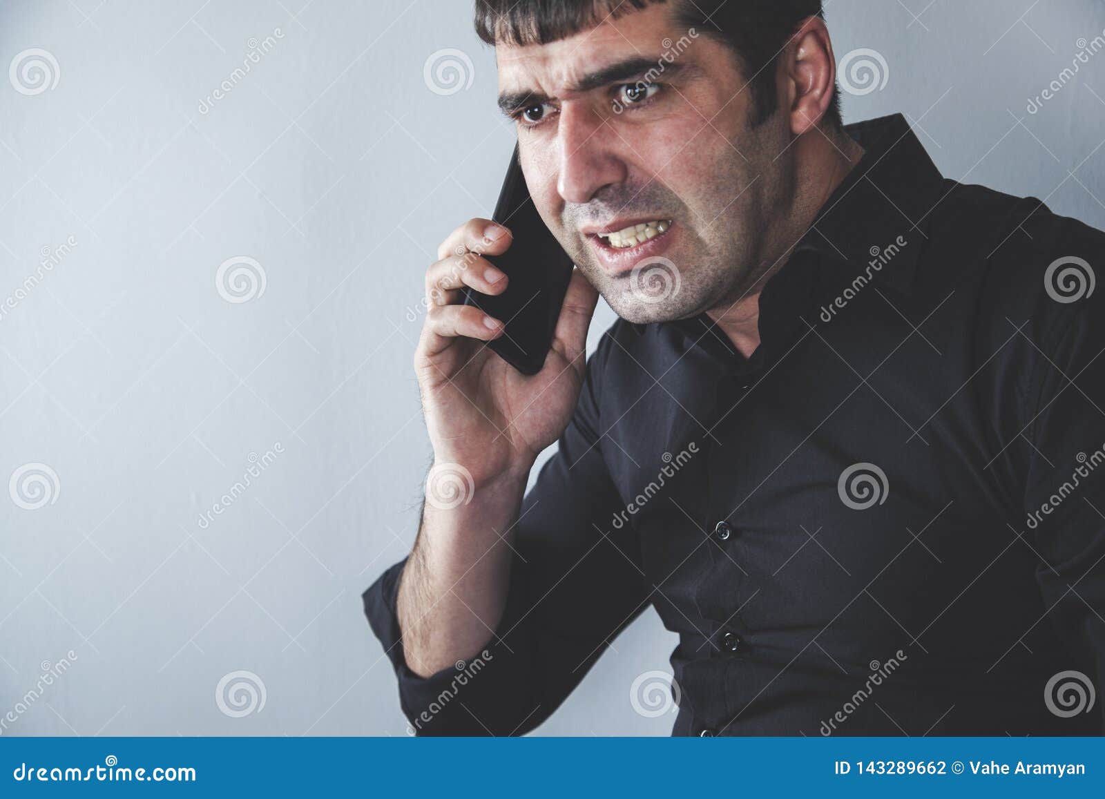 Angry man talking in phone stock photo. Image of white - 143289662
