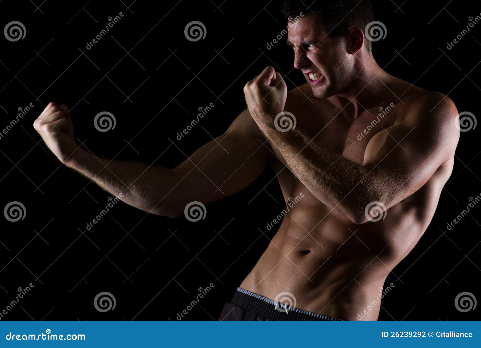 Angry Muscular Man in Attack Pose on Black Stock Photo - Image of ...