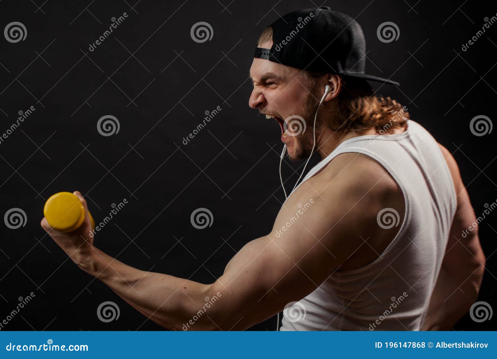 Angry Muscular Man is Training with Dumbbell Stock Photo - Image of ...