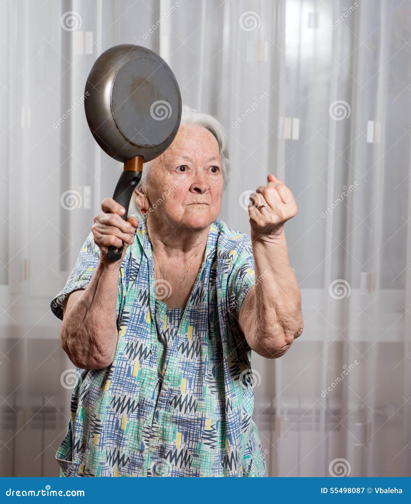Angry old woman with a pan stock image. Image of portrait - 55498087