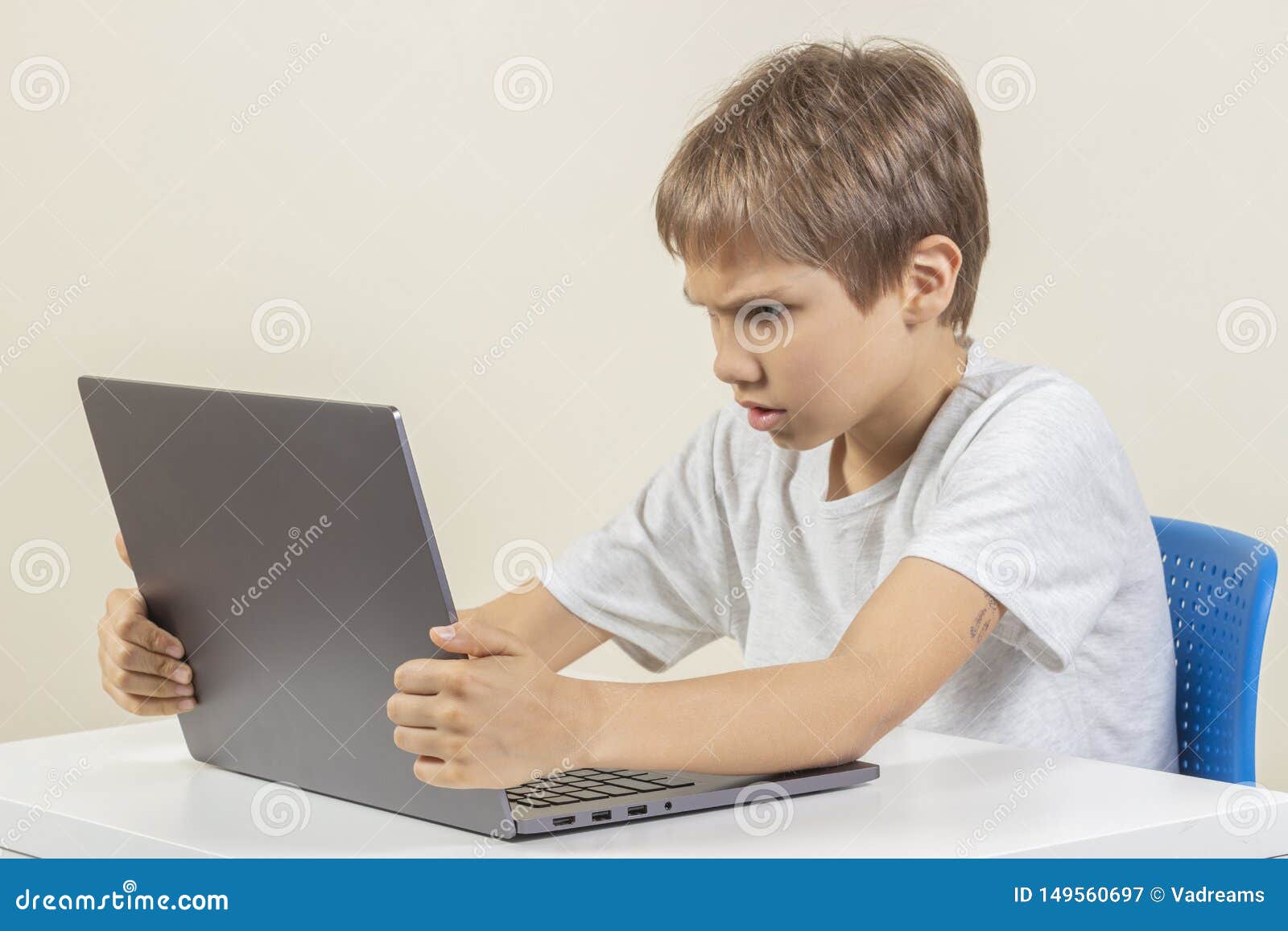 Angry Sad Boy with Laptop Computer Sitting at the Table Stock Image ...