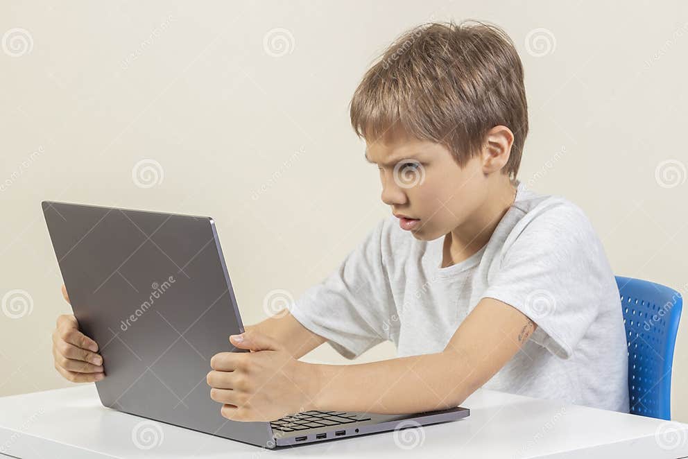 Angry Sad Boy with Laptop Computer Sitting at the Table Stock Image ...