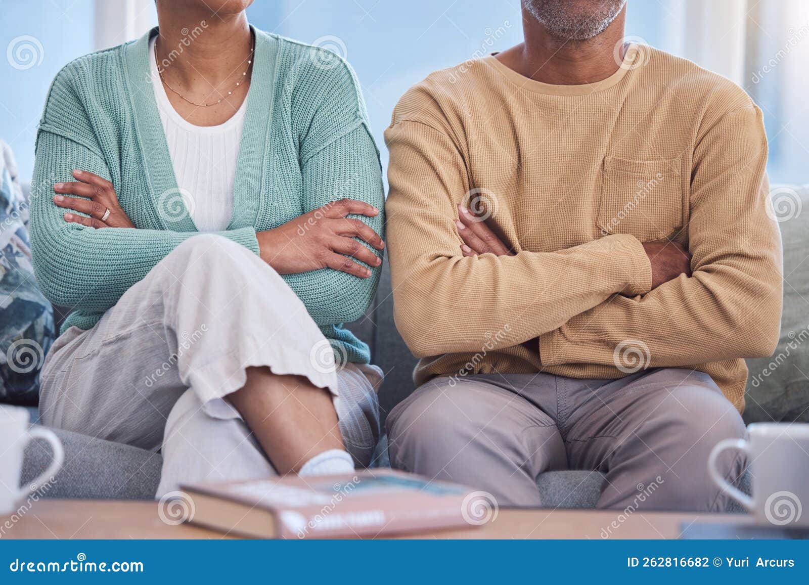 Angry Upset And Annoyed With A Couple Sitting Arms Crossed On A Sofa