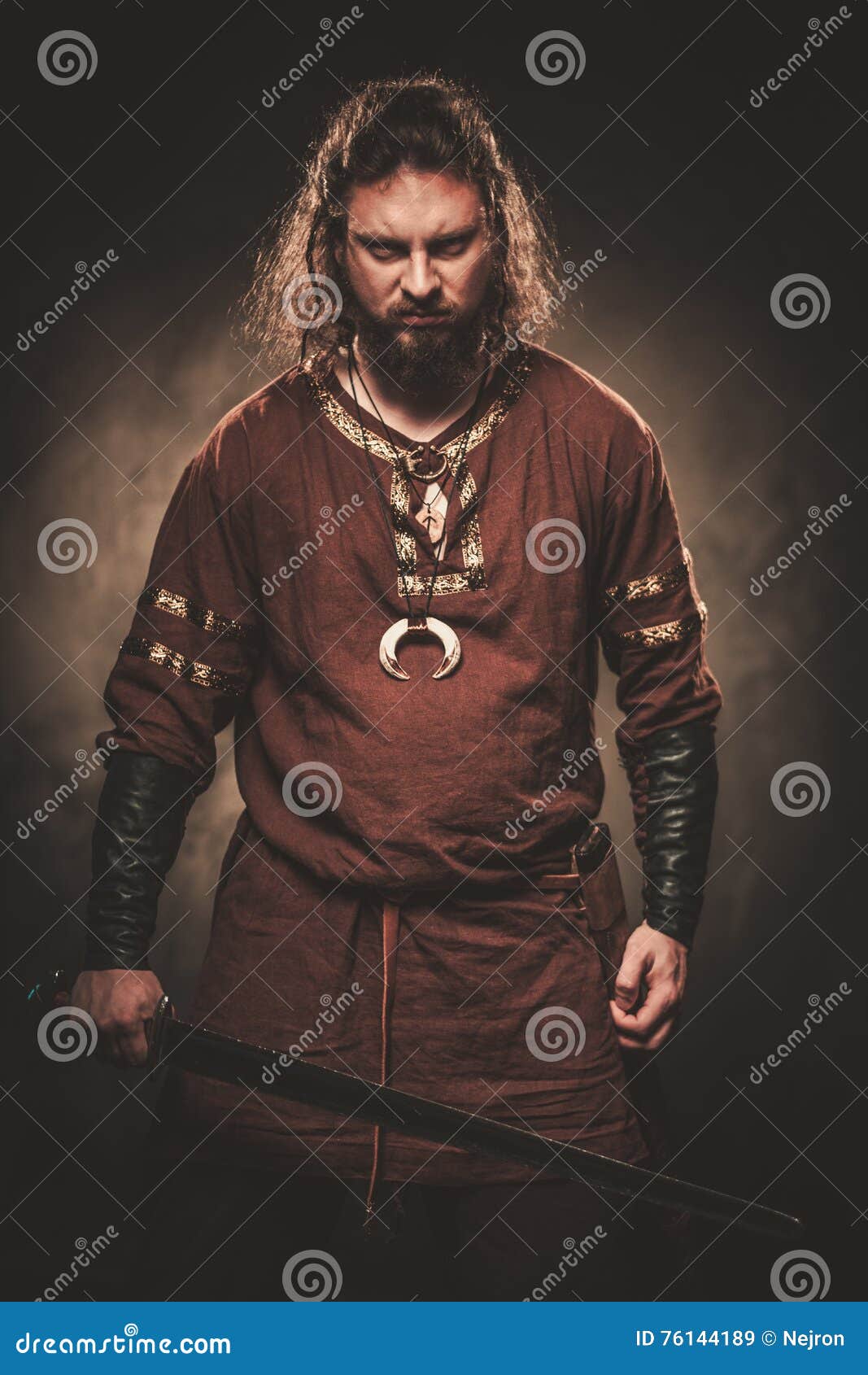 Angry Viking with Sword in a Traditional Warrior Clothes, Posing on a ...