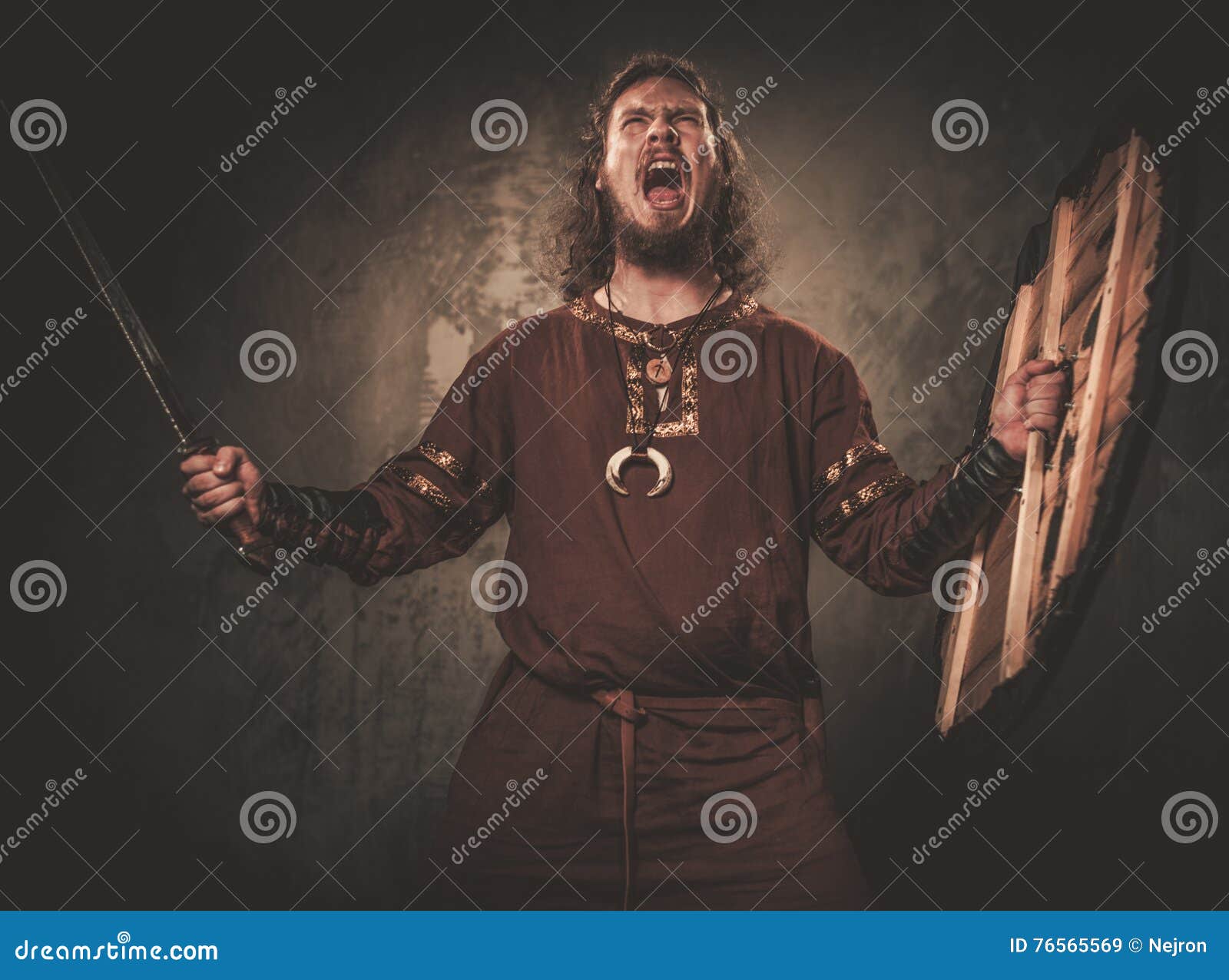 Angry Viking with Sword in a Traditional Warrior Clothes, Posing on a ...