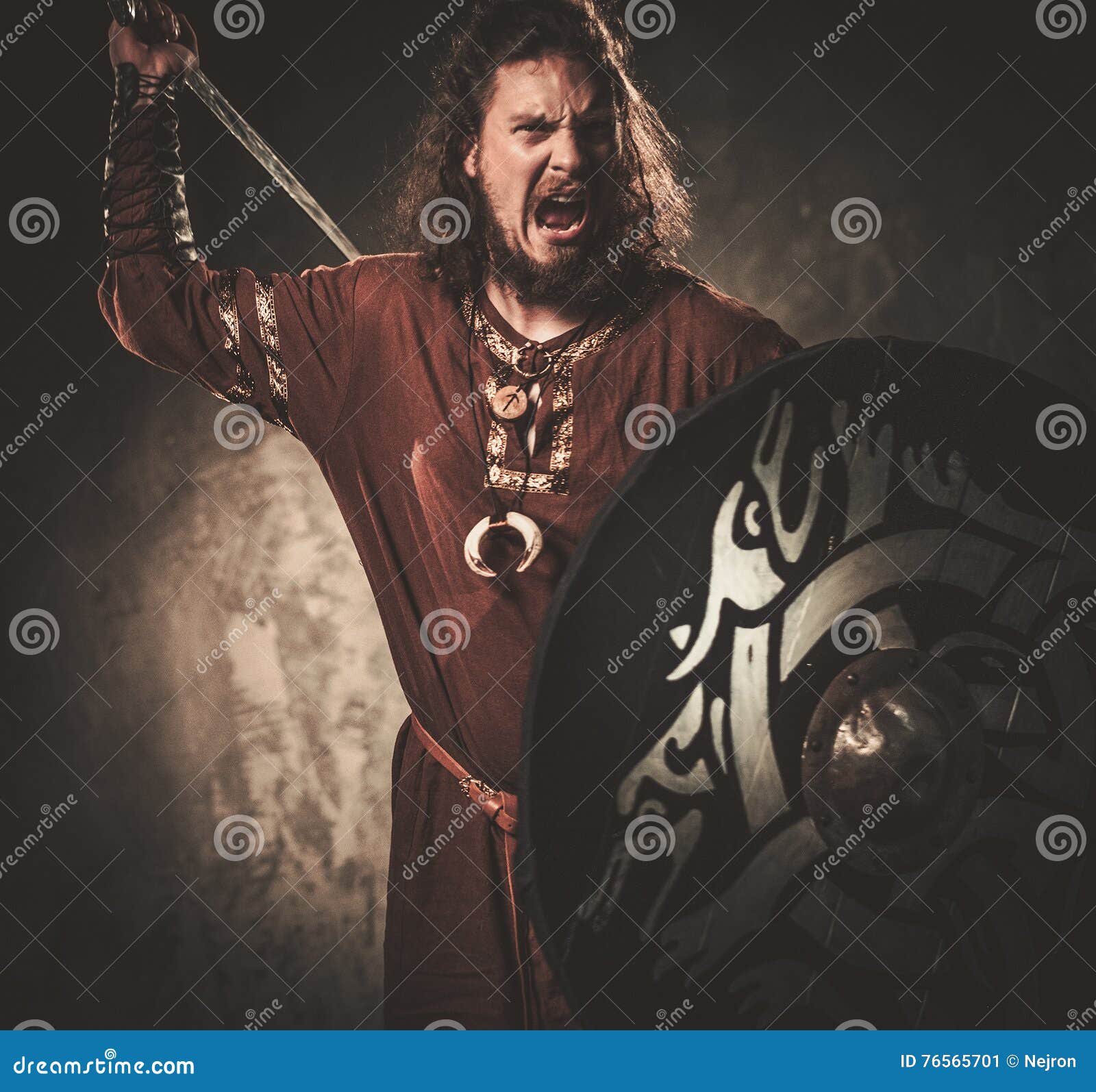 Angry Viking with Sword in a Traditional Warrior Clothes, Posing on a ...