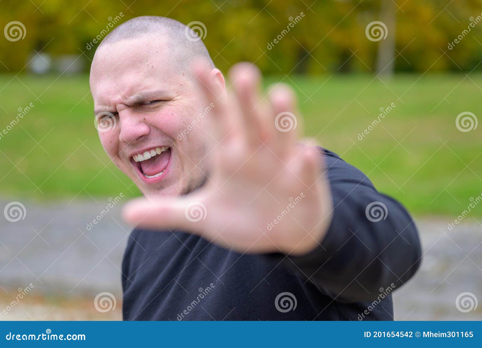 Angry Young Man Shouting and Gesturing with a Hand Stock Photo - Image ...