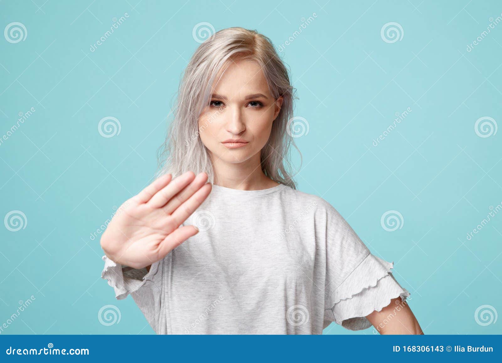 Angry Young Person Showing Stop Sign in Th E Blue Studio. Stock Image ...