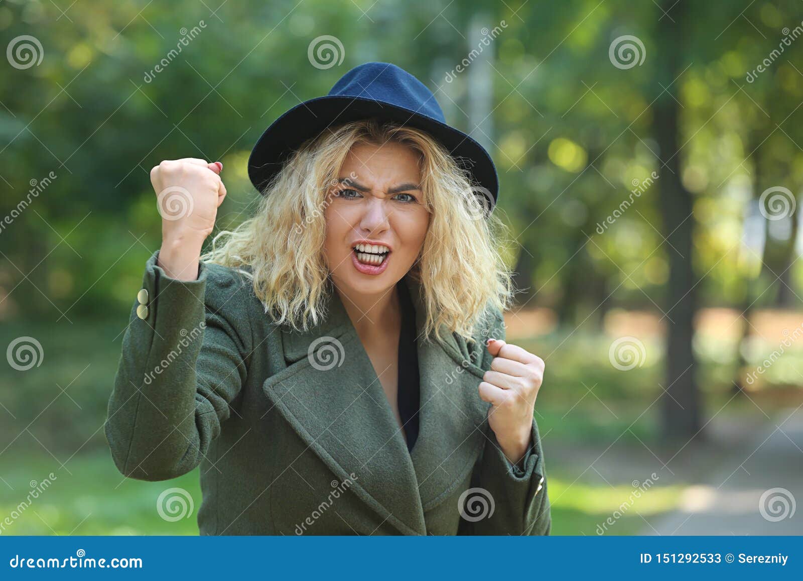 Angry young woman outdoors stock image. Image of fists - 151292533