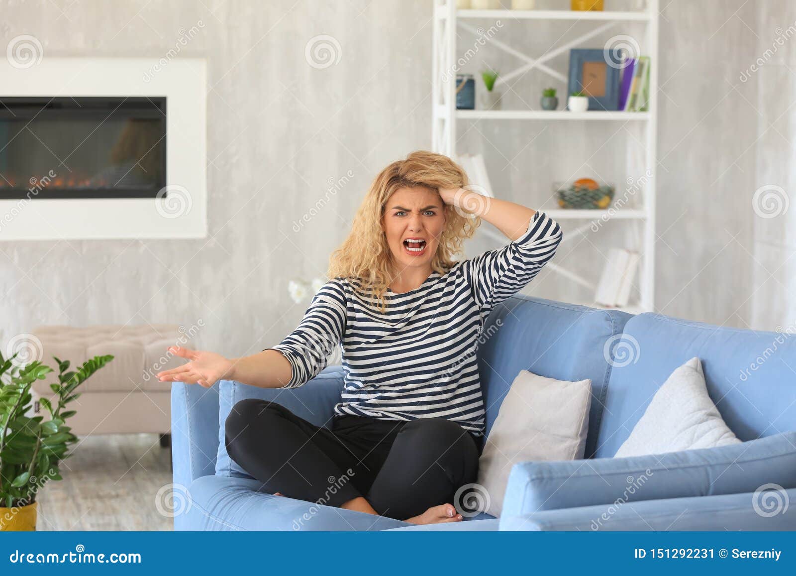 Angry Young Woman Sitting on Sofa at Home Stock Image - Image of ...