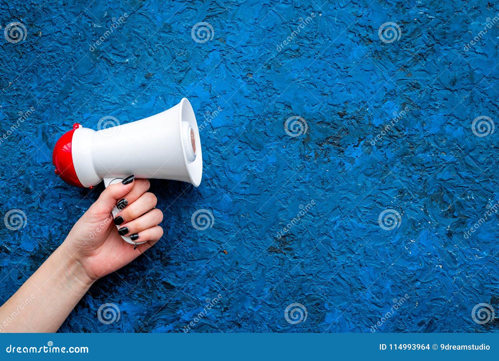 Announcement Concept. Megaphone in Hand on Blue Background Top View ...