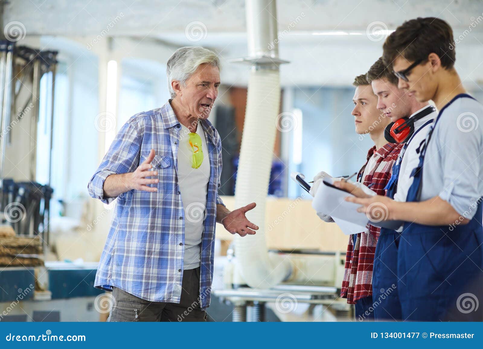 Annoyed Carpenter Dressing Down Young Workers Stock Image - Image of ...