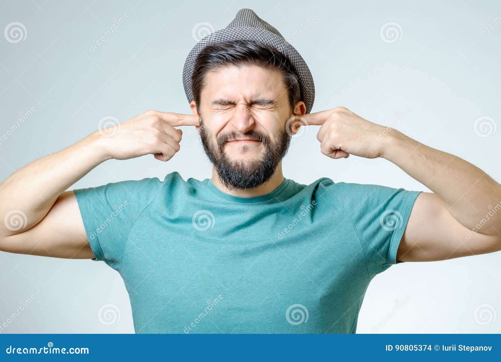 Annoyed Young Man Plugging Ears with Hands Stock Photo - Image of audio ...