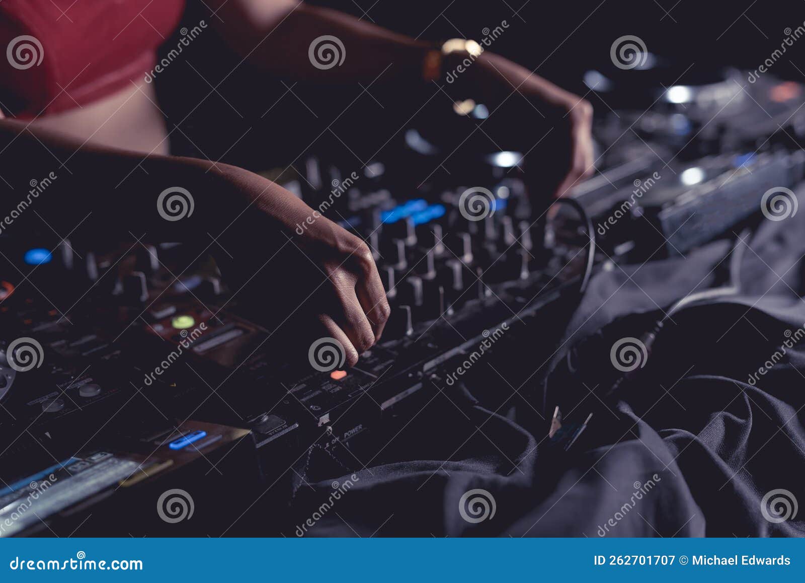An Anonymous Female DJ Adjusting the EQ Controls on the Mixer Stock ...