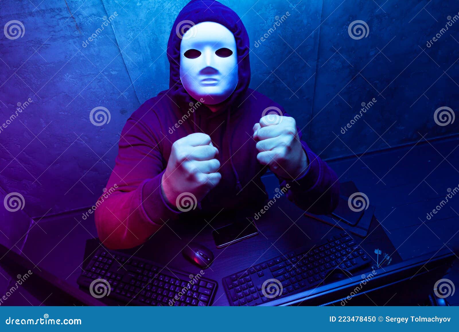 Anonymous Hacker Wearing Face Mask Working on Computer in Dark Room ...