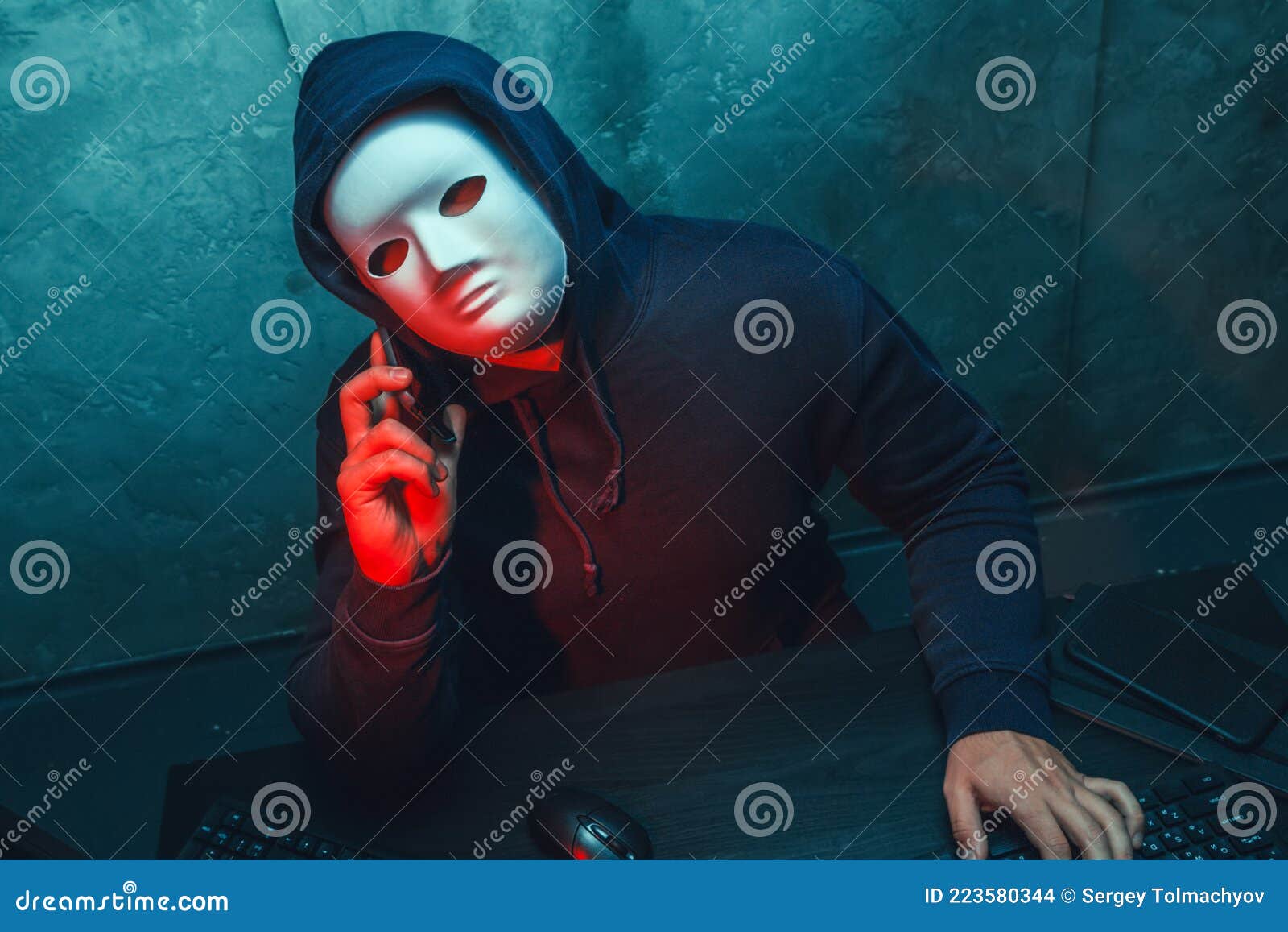 Anonymous Hacker Wearing Face Mask Working on Computer in Dark Room ...
