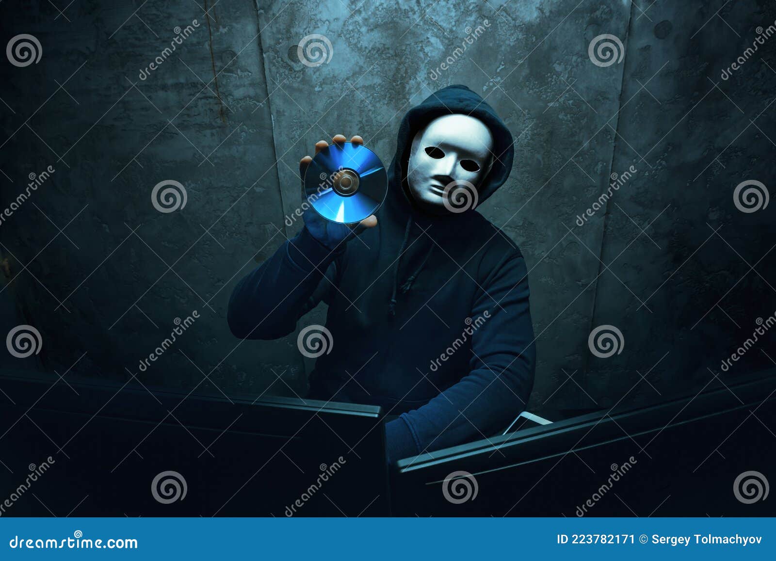 Anonymous Hacker Wearing Face Mask Working on Computer in Dark Room ...