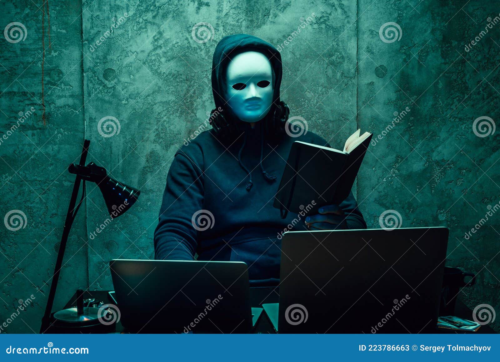 Anonymous Hacker Wearing Face Mask Working on Computer in Dark Room ...