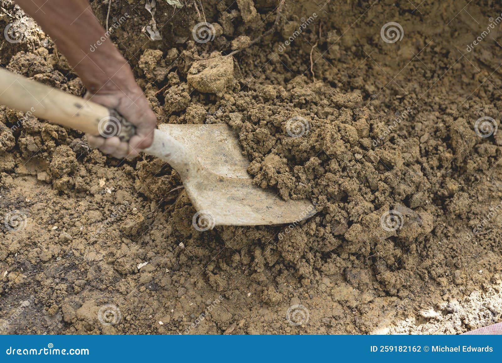 An Anonymous Man Digging into the Ground with a Shovel, Excavating a ...