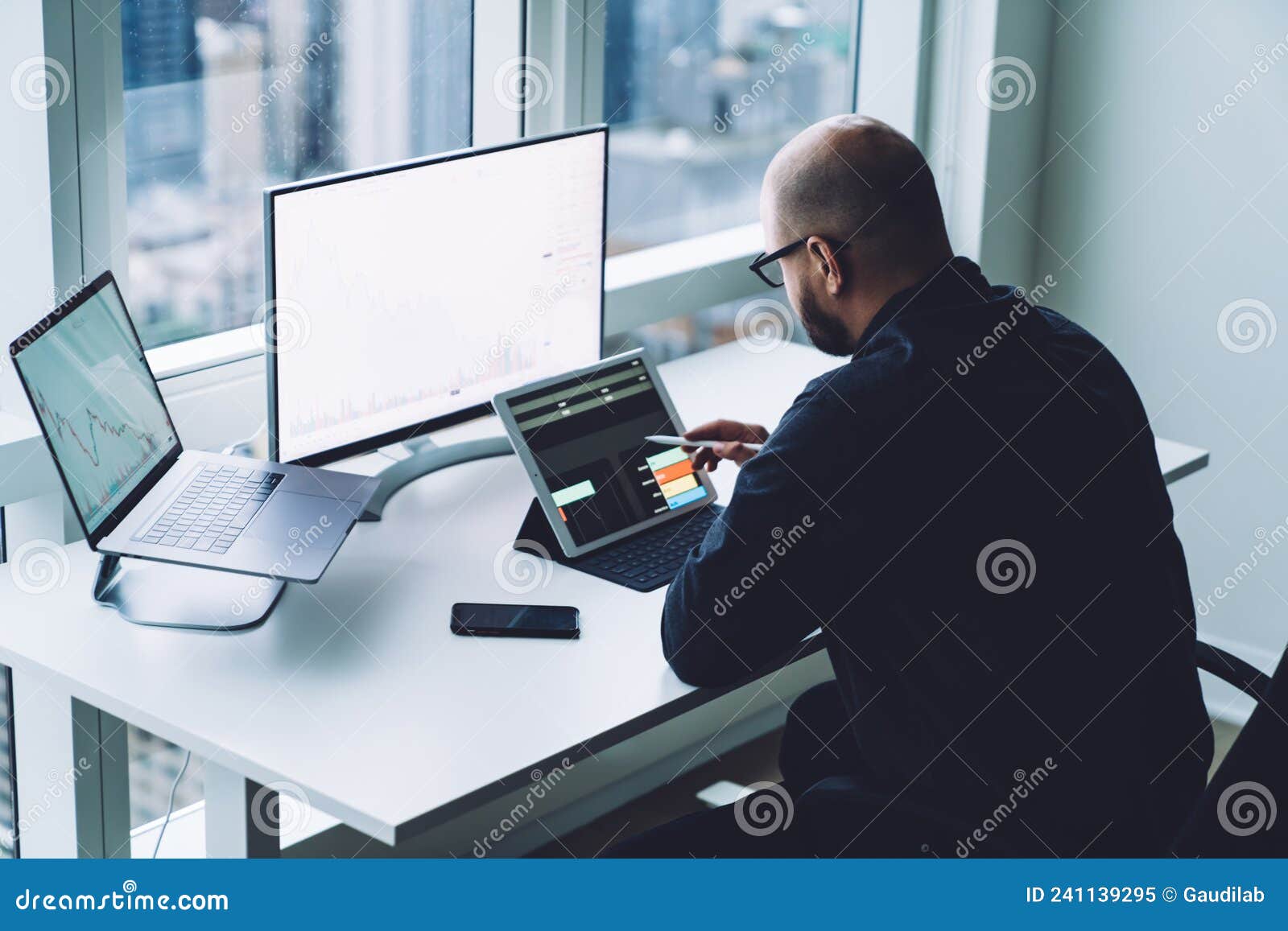 Anonymous Trader Analyzing Data on Tablet and Computers in Office Stock ...