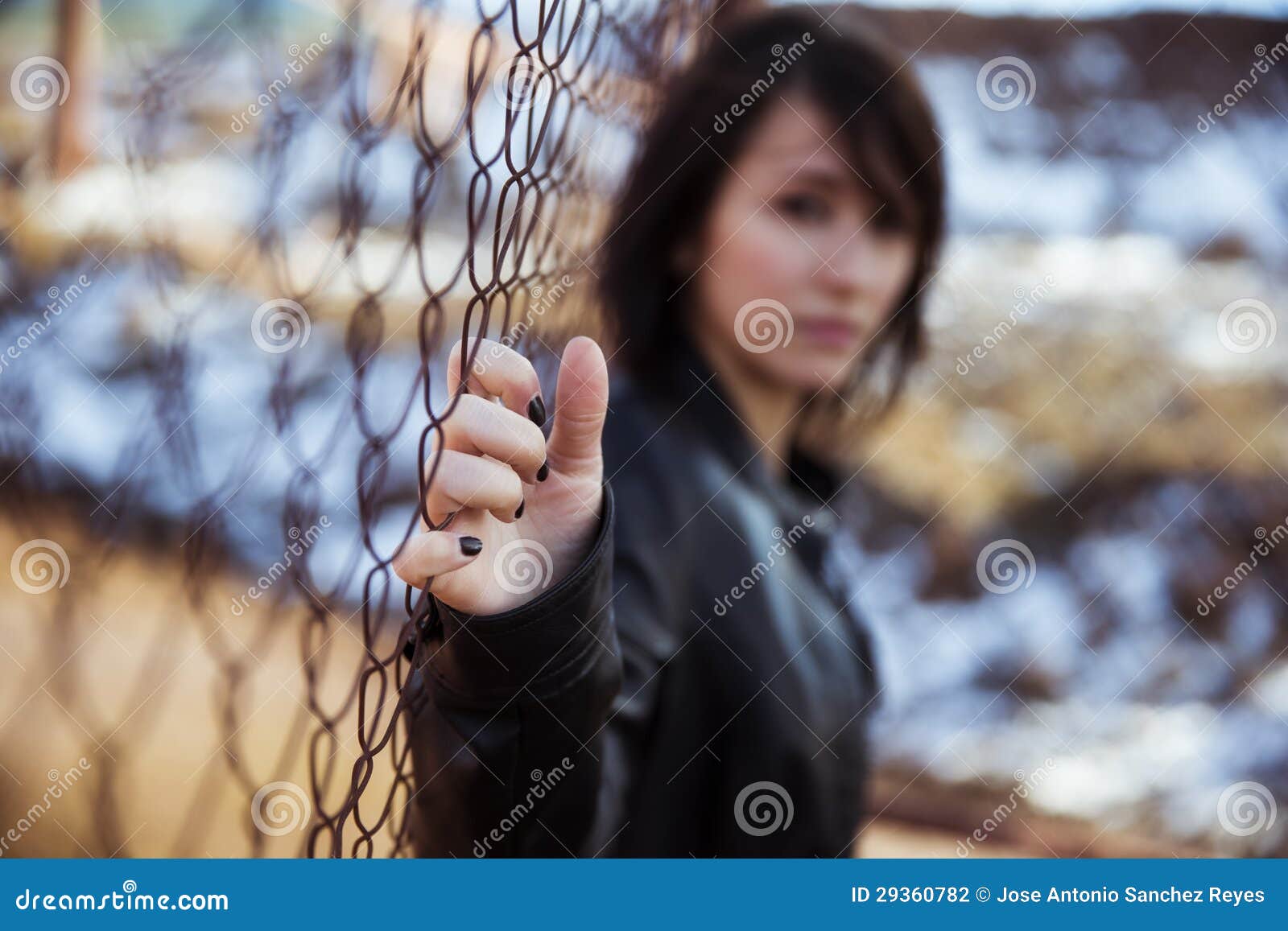 Anonymous Woman Portrait Over Fence Stock Photo - Image of jacket ...