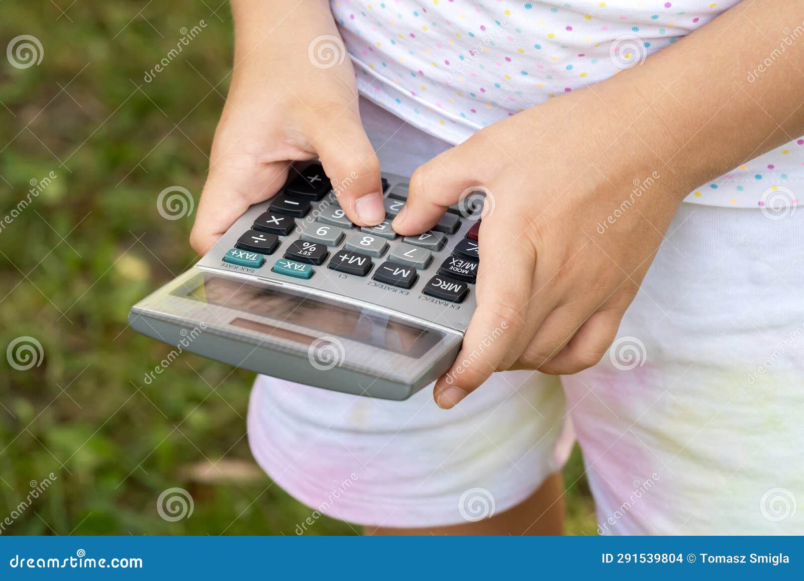 Anonymous Young Girl Child Using a Generic Calculator, Holding it in ...