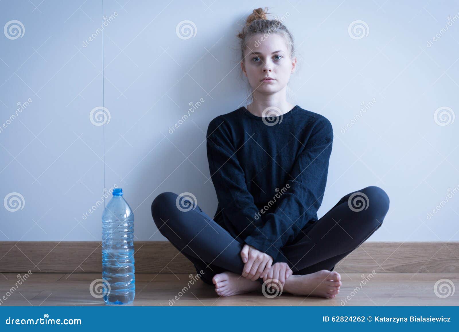 Anorexic Girl Lying On Floor, Suffering From Stomach Pain, Nausea ...