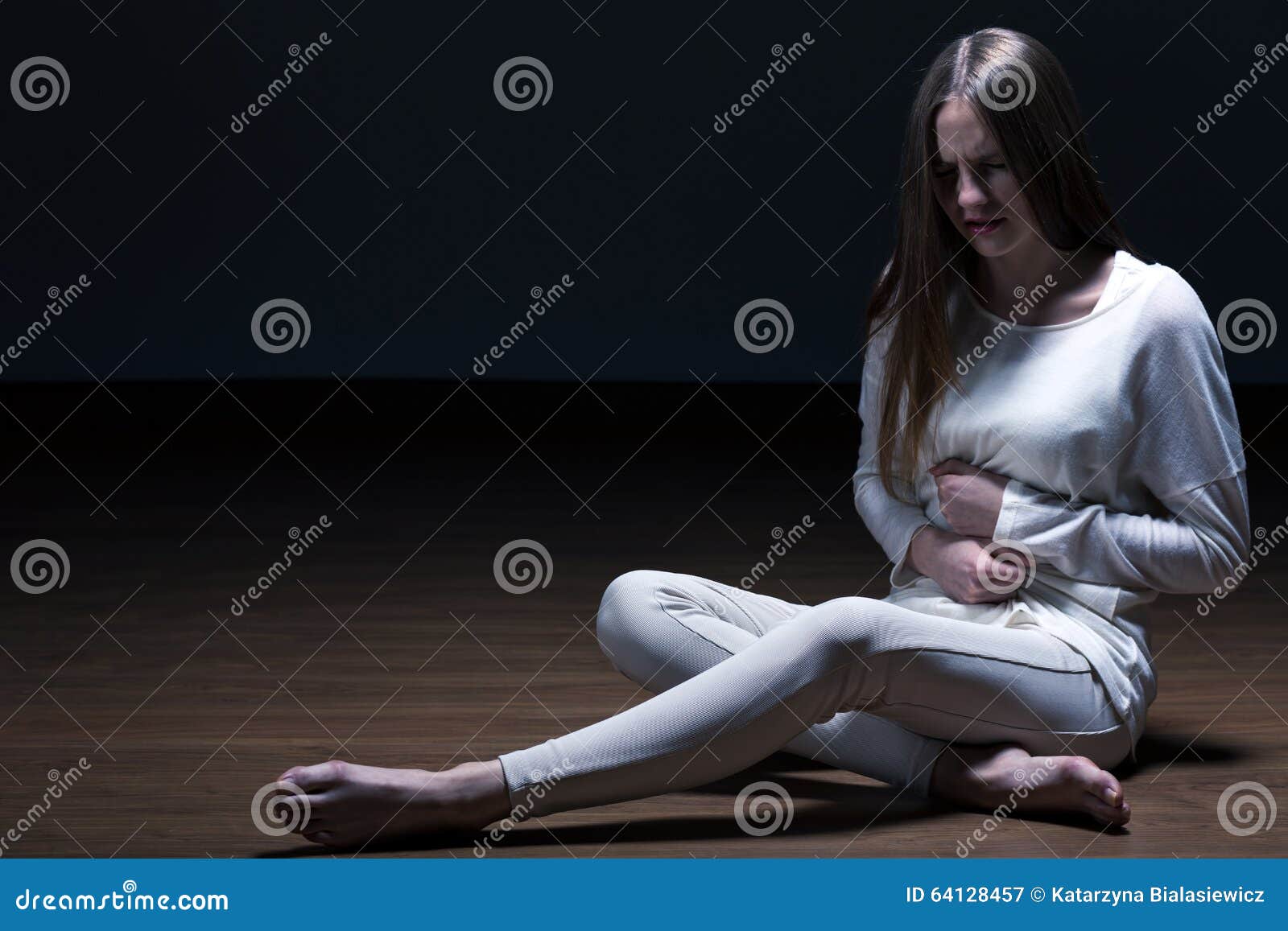 Anorexic Girl Lying On Floor, Suffering From Stomach Pain, Nausea ...