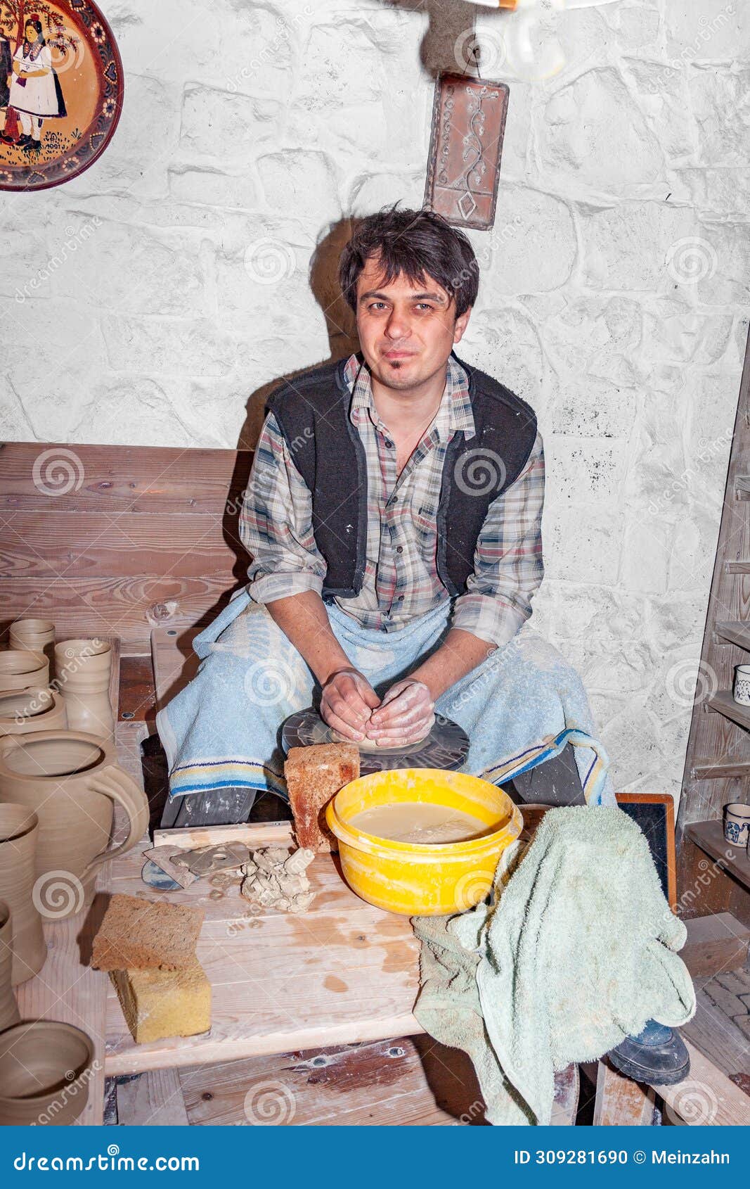 A Potter Demonstrates Pottery Making with a Turn Table and Pottery Clay ...