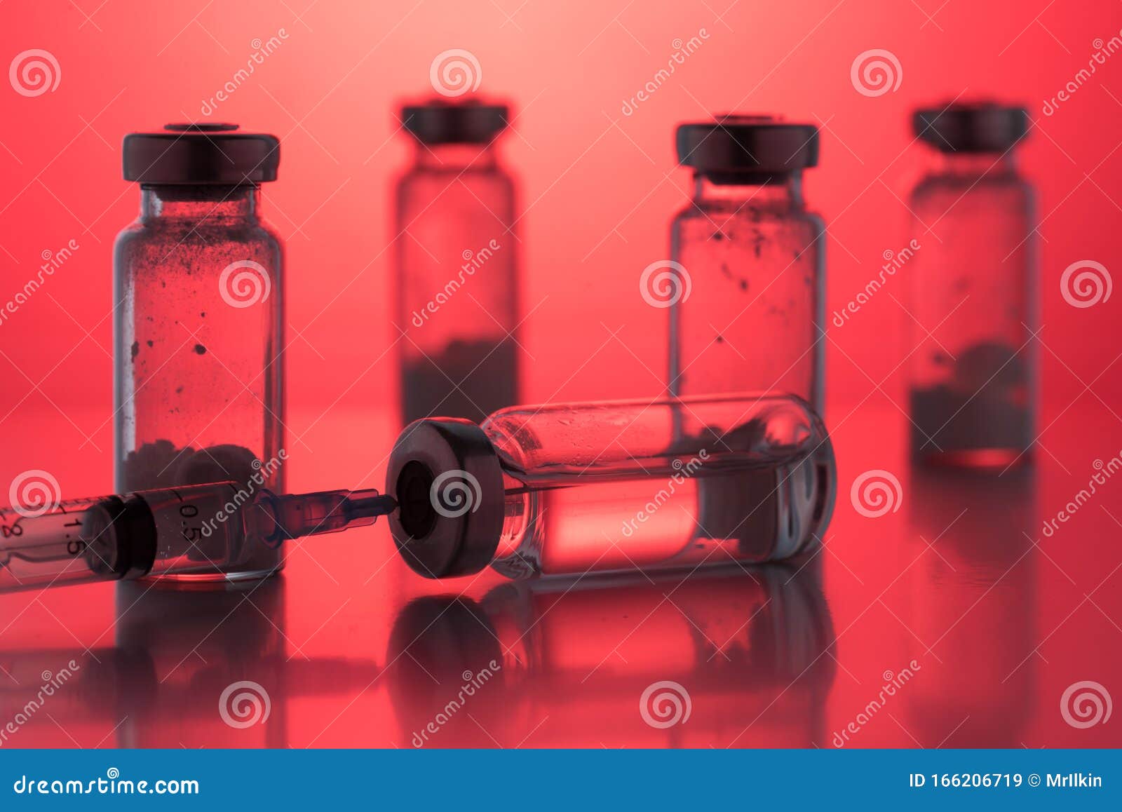 Antibiotic Injection Bottles with a Plastic Disposable Syringe on a Red ...