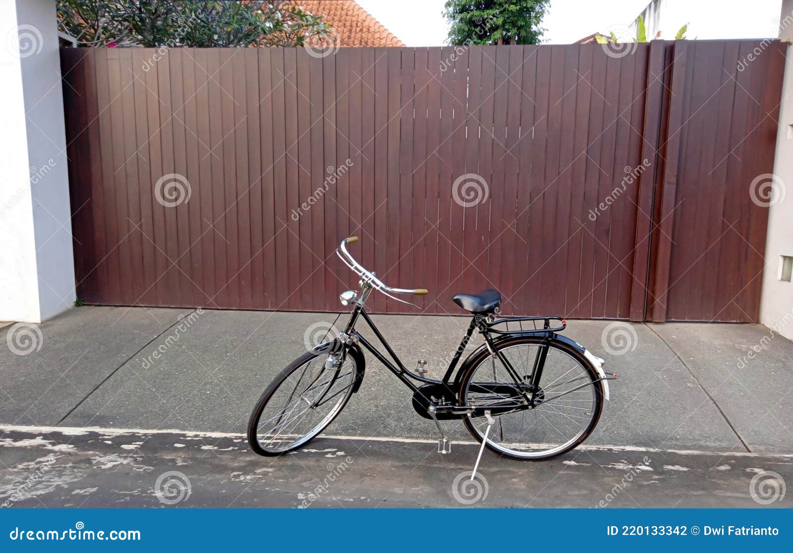 An Antique Bicycle Park in Front of Gate with Wooden Style Stock Photo ...