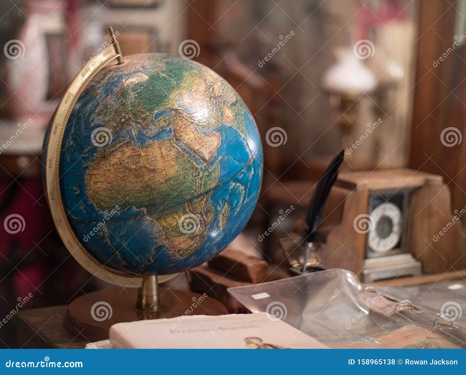 An antique globe on a desk stock photo. Image of europe - 158965138