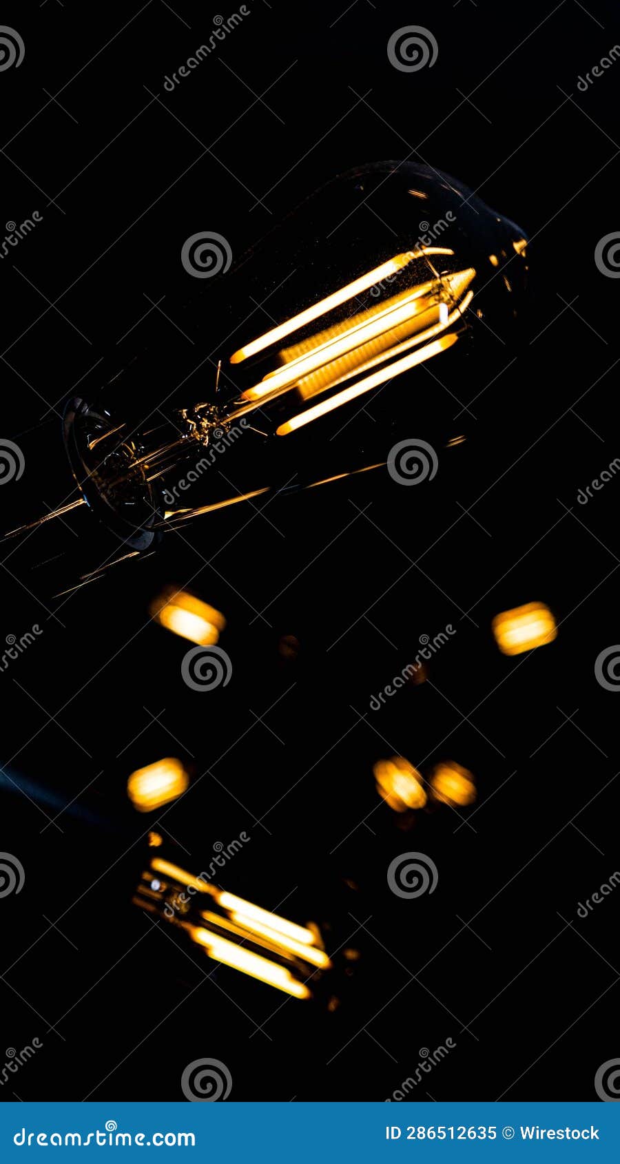 Antique Light Bulb Illuminated in a Dark Setting, with Rays of Light ...