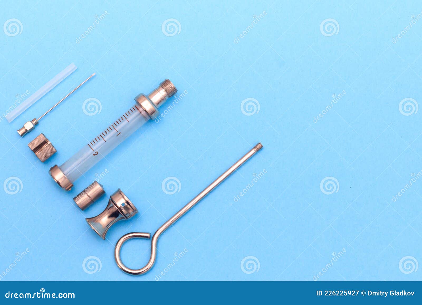 Antique Syringe Disassembled into Details on a Blue Background Stock ...