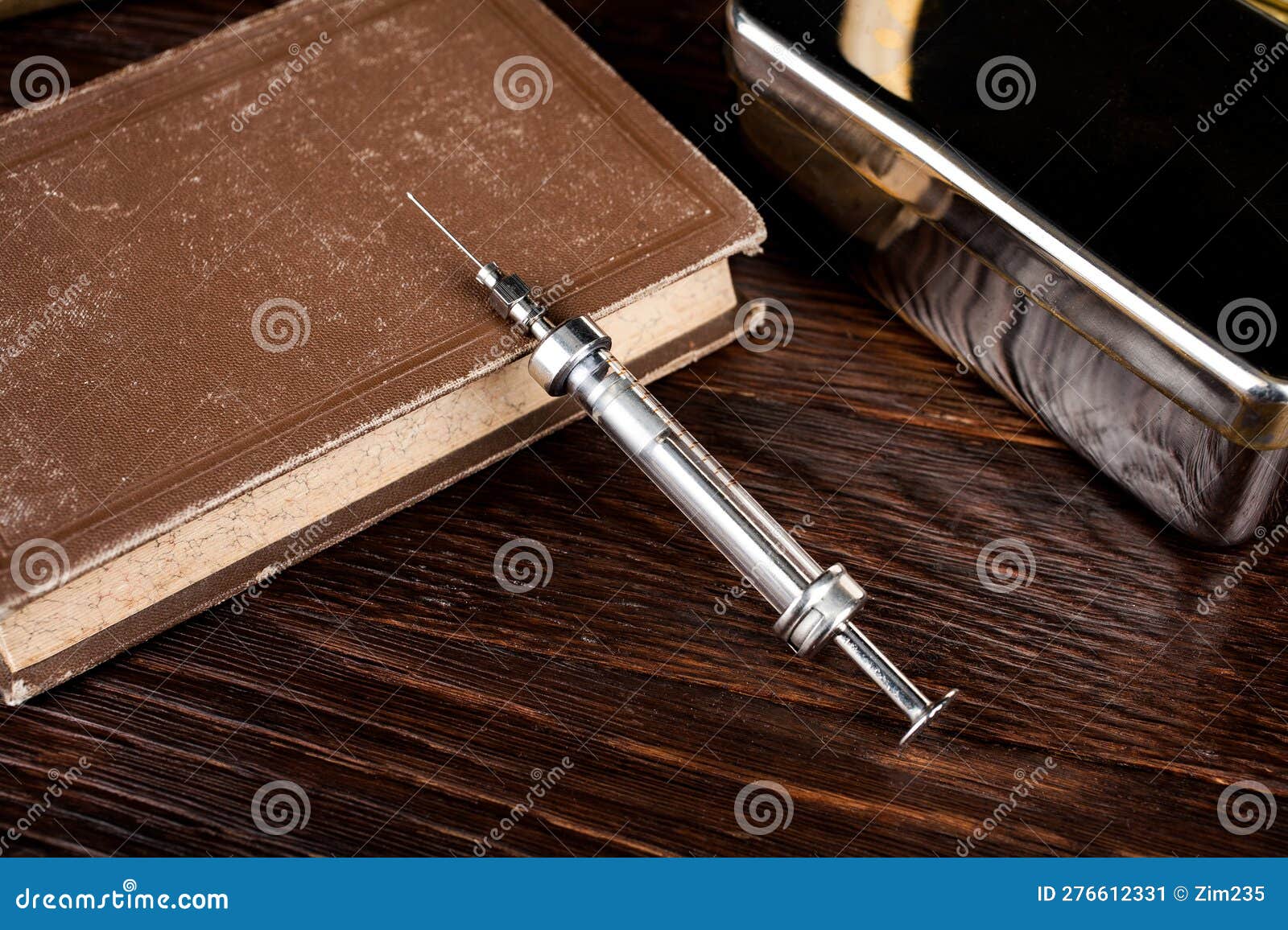 Antique syringe on a table stock image. Image of instrument - 276612331