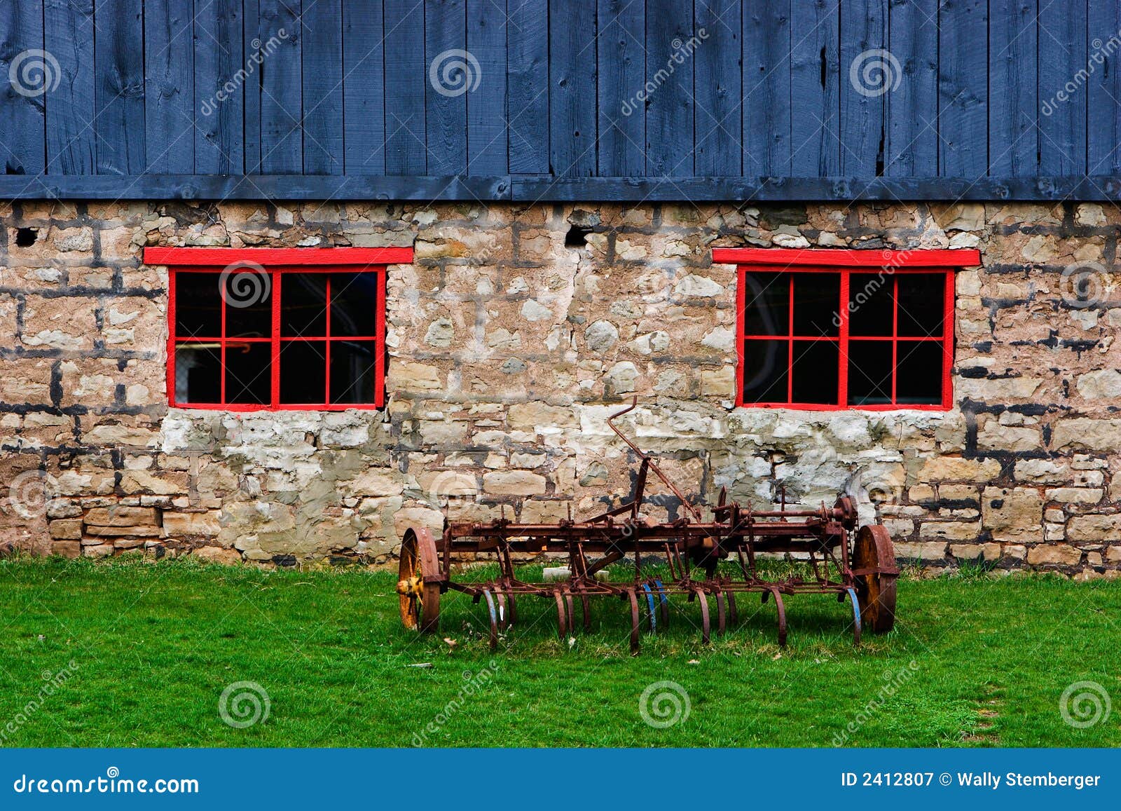 Antique Tiller beside a Barn Stock Image - Image of black, grass: 2412807