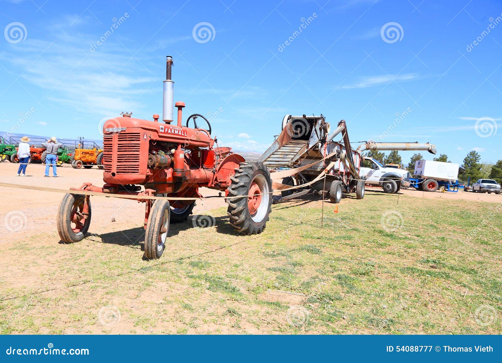 Antique Farmall Tractor Pulling & Powering Combine Harvester Editorial ...