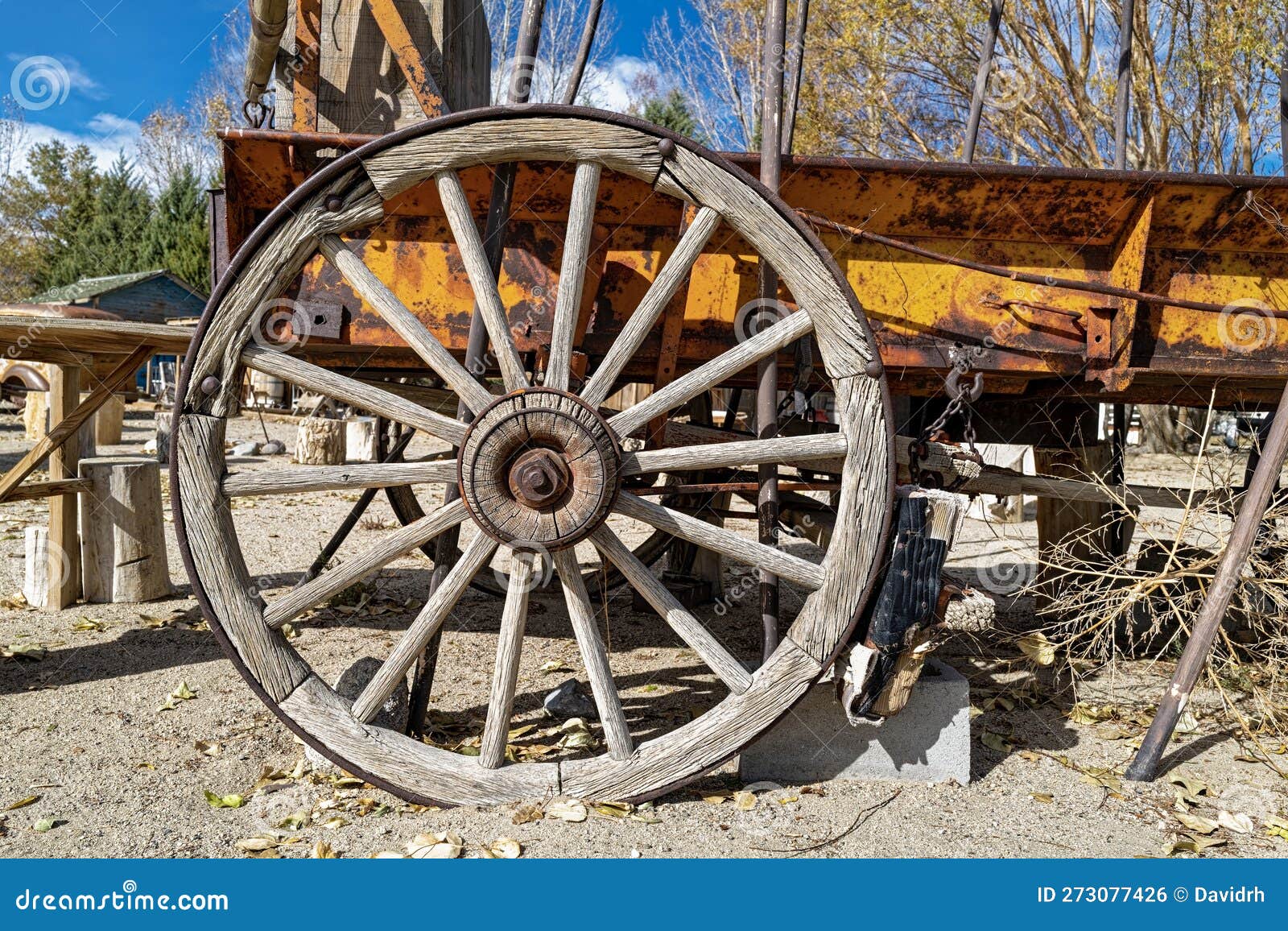 An Antique Wagon Wheel with Wooden Spokes on a Rusty Wagon Stock Photo - Image of invader ...