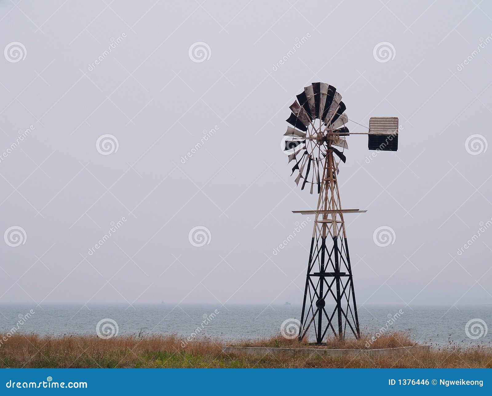 Antique Wind Mill by the Sea Stock Photo - Image of moving, green: 1376446